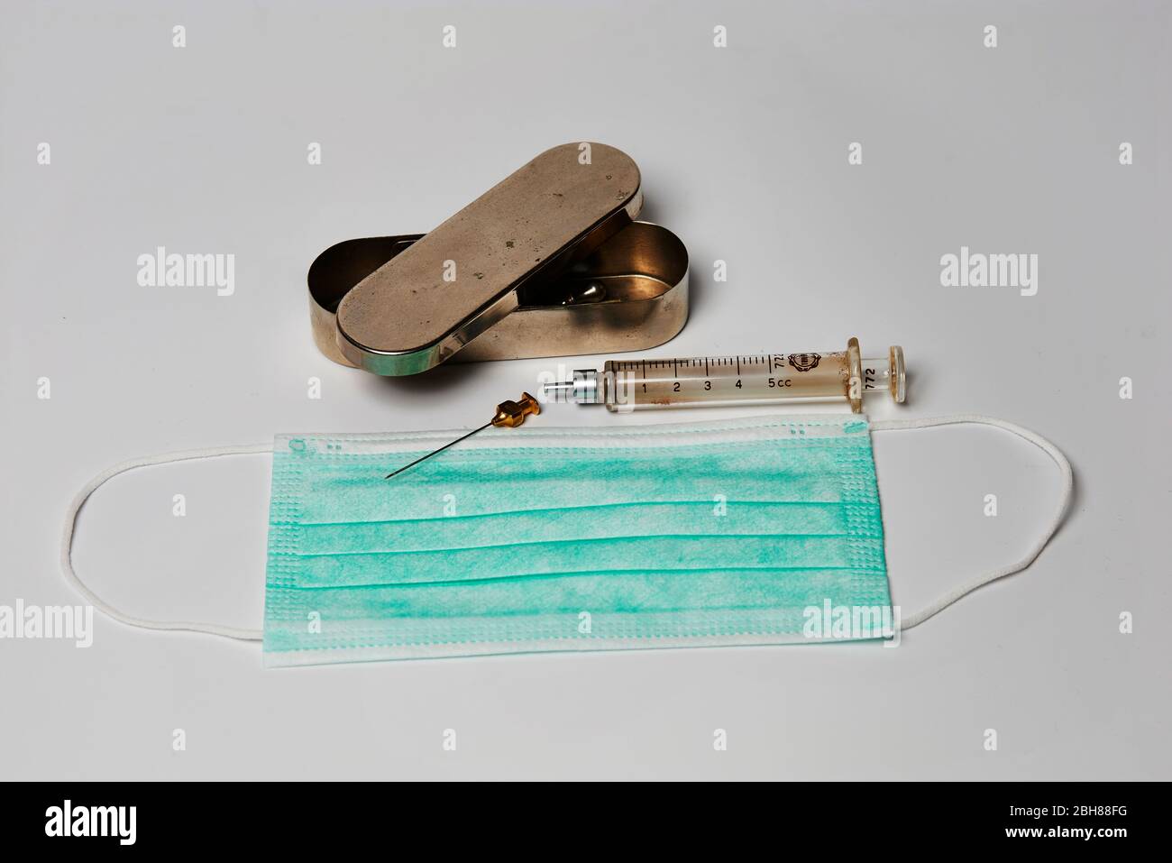 still life medical syringe with medical mask on white background Stock ...