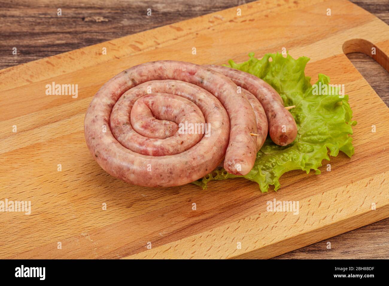 Raw pork sausage ring for grill Stock Photo - Alamy