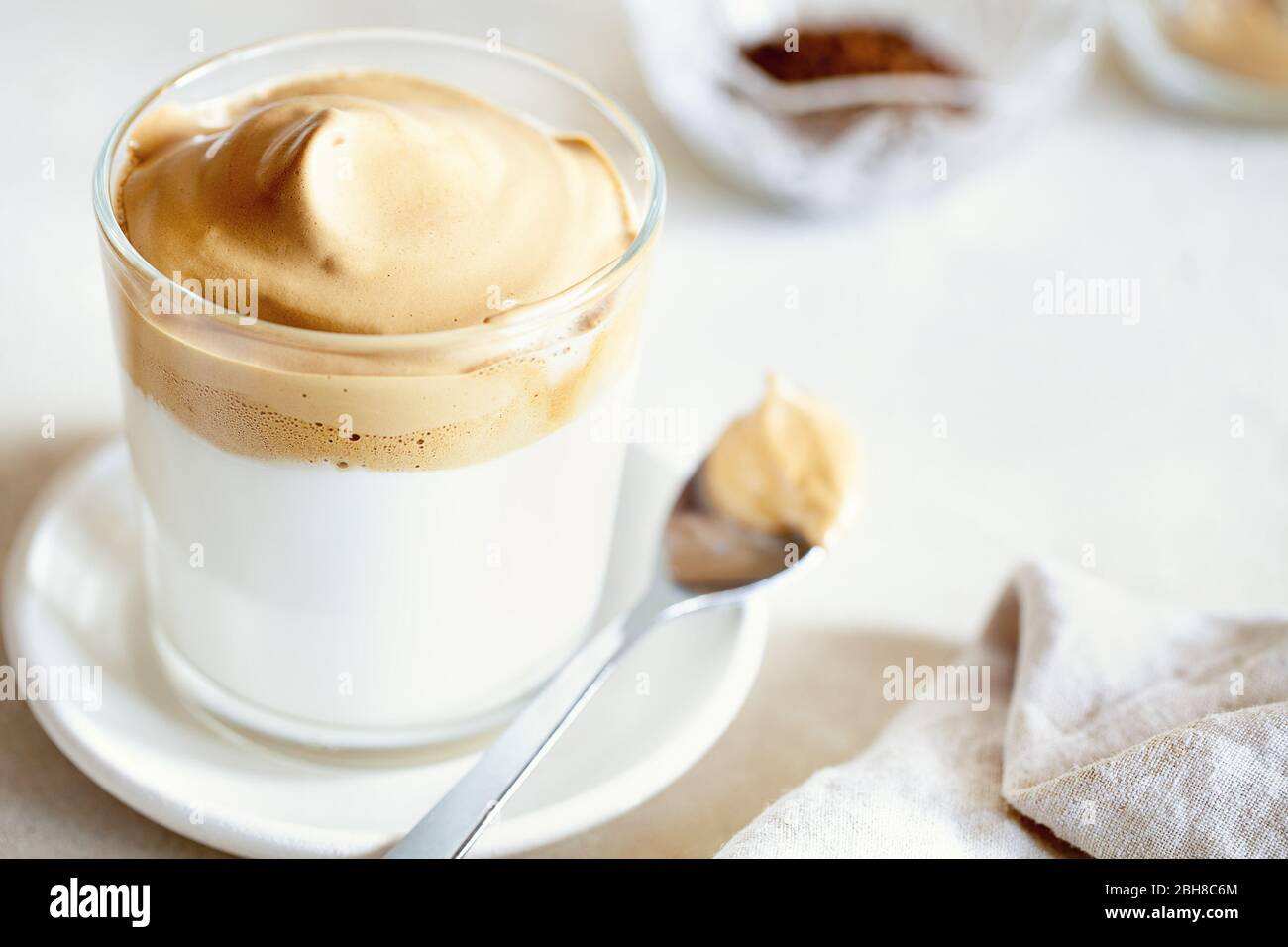 Trendy fluffy creamy whipped iced Dalgona coffee on white background ...