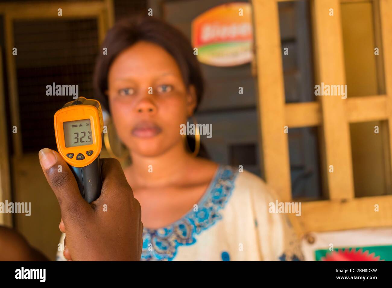Close-up shot of a young african woman using infrared forehead ...