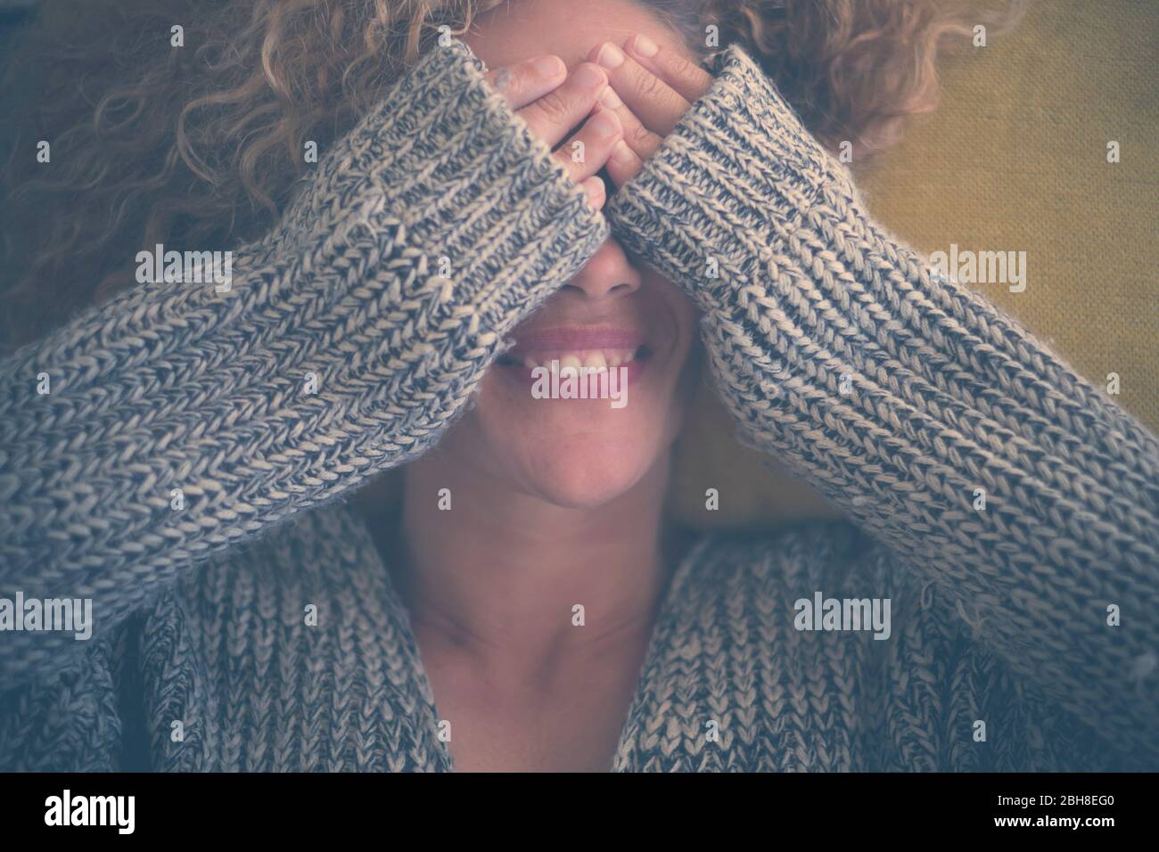 Young woman at home hides the face with hands, portrait Stock Photo - Alamy