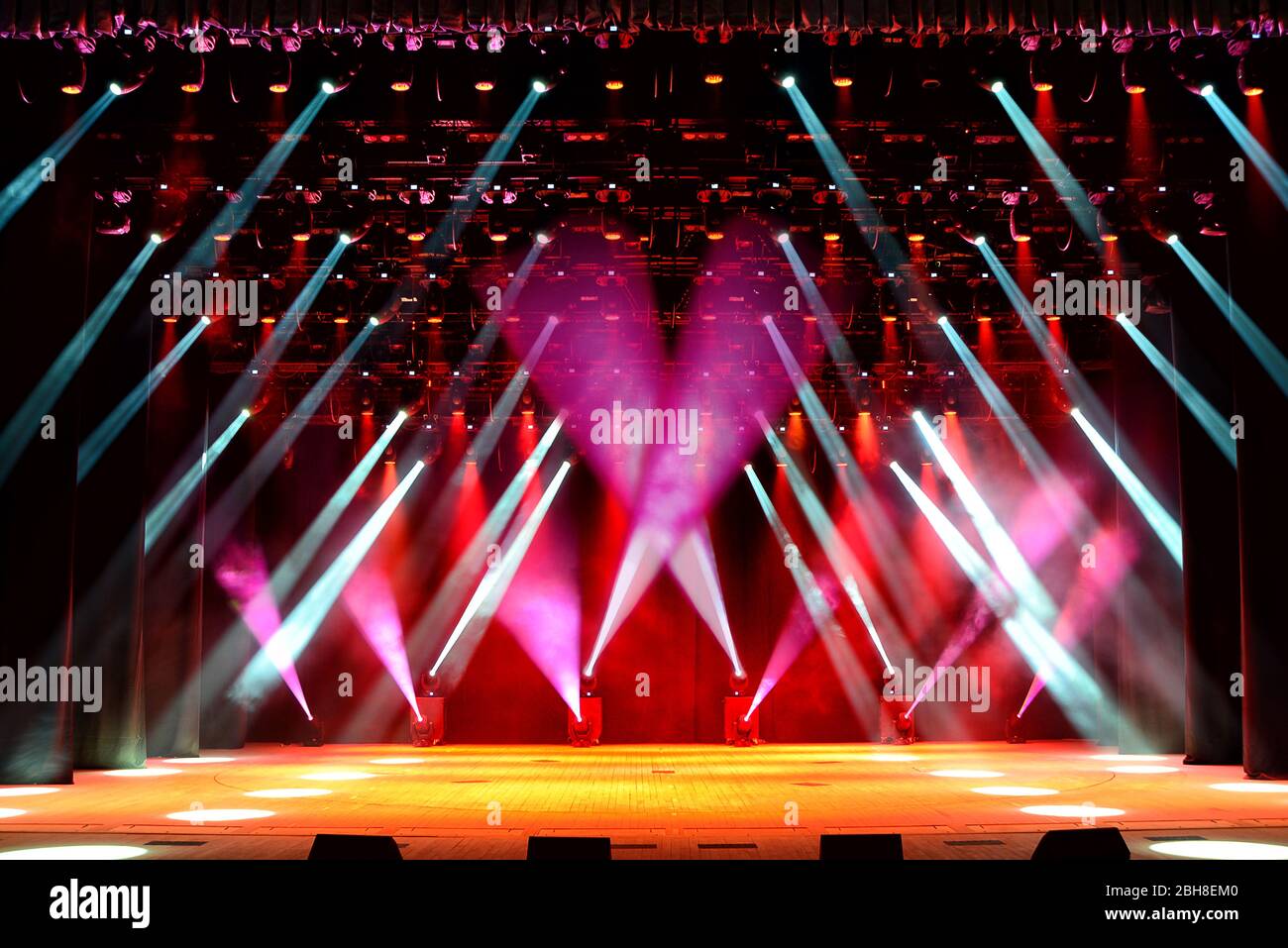 Illuminated empty show stage with red light beams and stage fog Stock ...