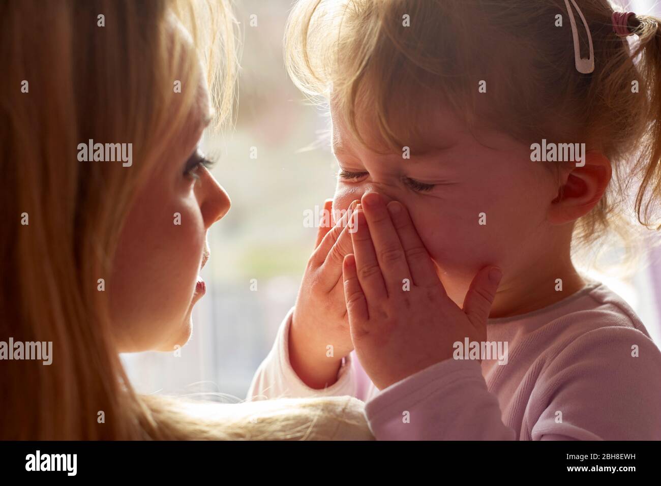 Little girl crying with mother consoling her Stock Photo - Alamy