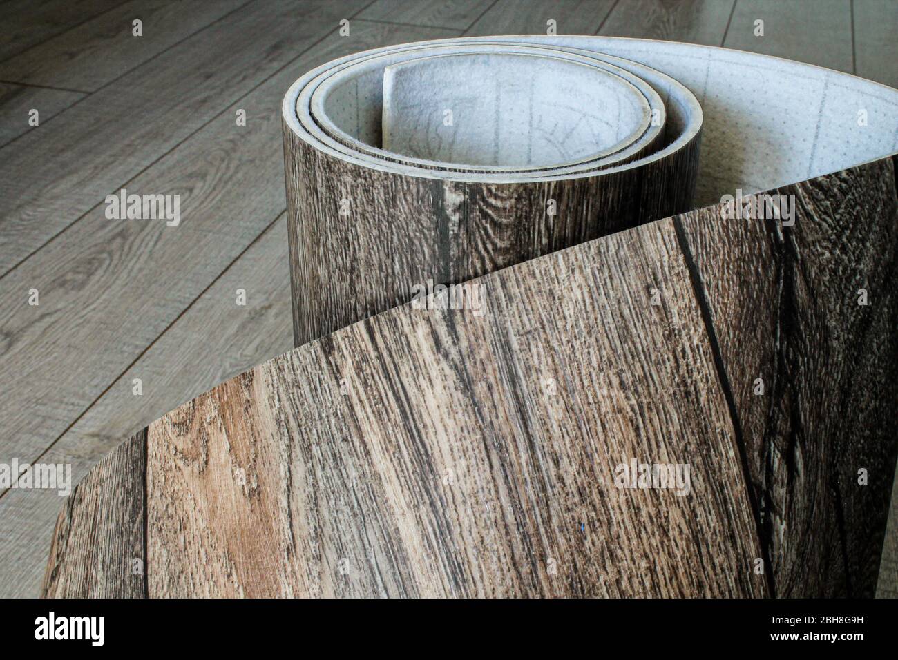 Roll of linoleum with a wood texture. Types of floor coverings Stock ...