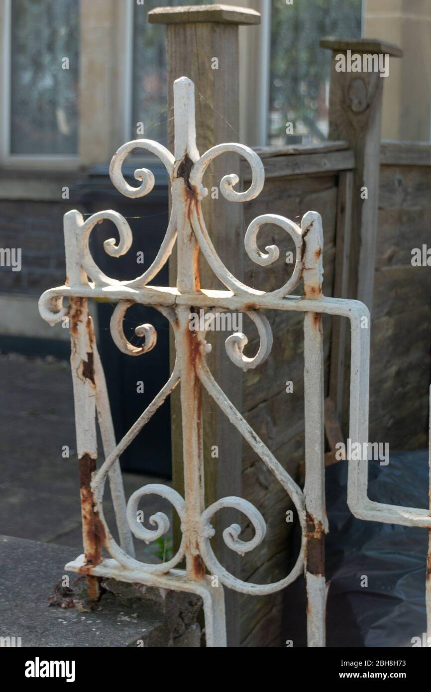 a close up view of a old rusted metal gate with the white peeling off ...