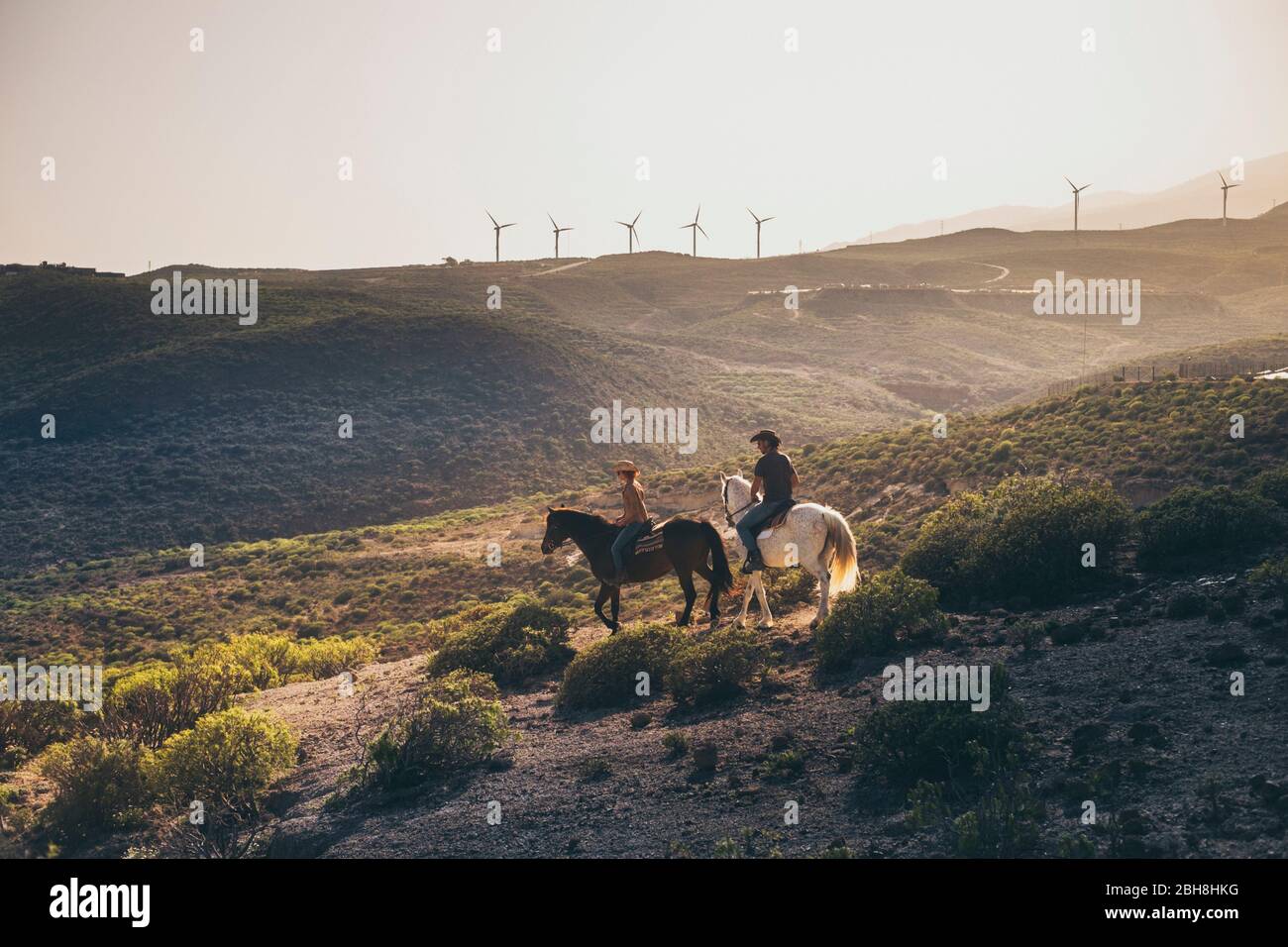 Beautiful landscape on mountain with windmills in background and couple ...