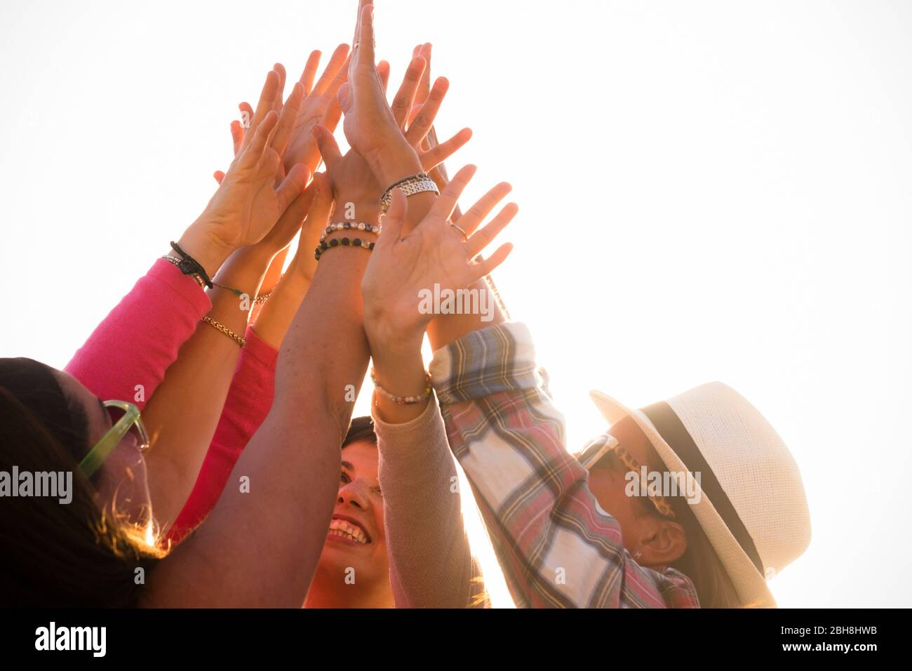 Success victory and teamwork concept with group of young nice women ...