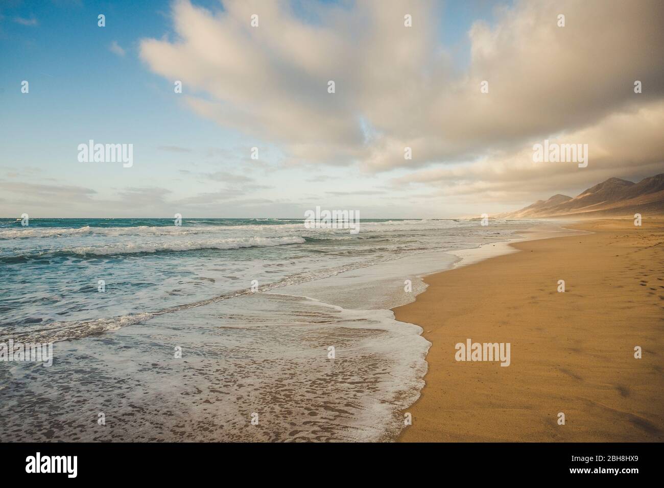 Lonely beach with beautiful mountain background with cloudy sky ...