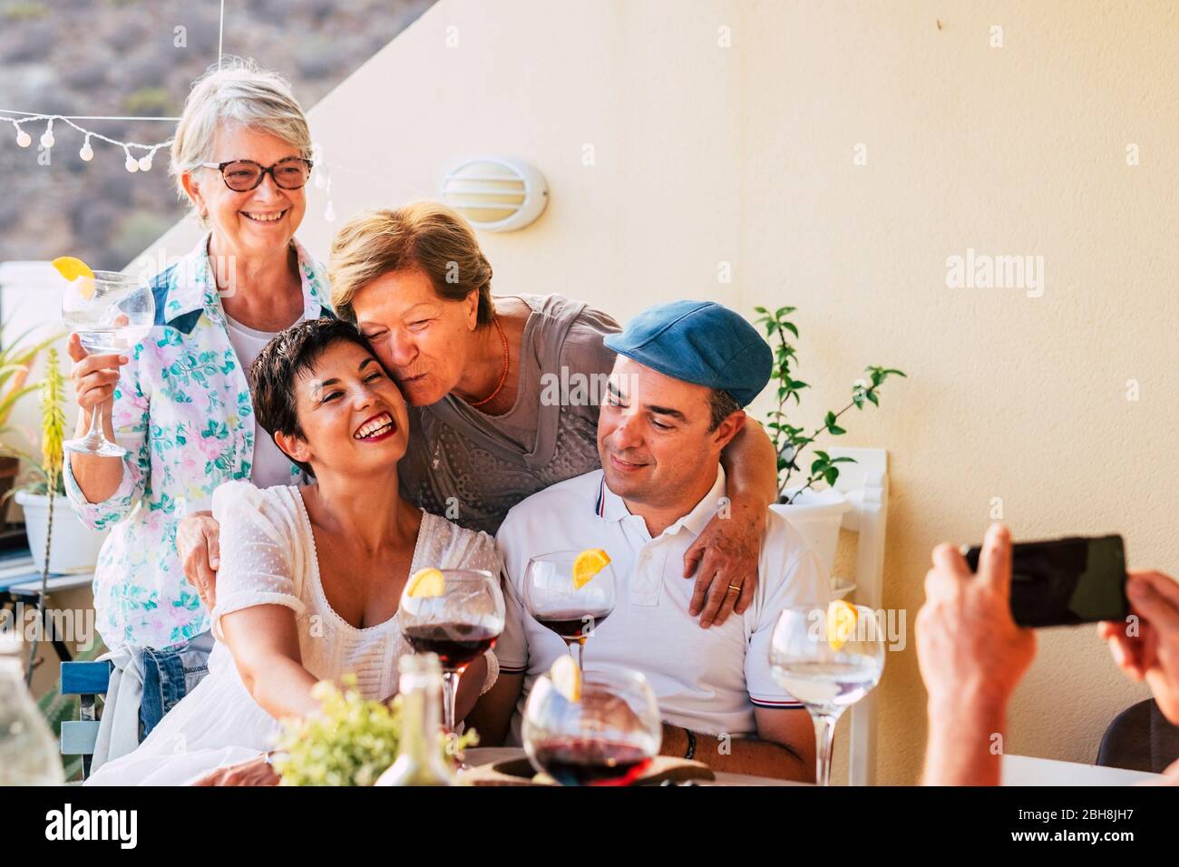 Family portrait with young couple and mothers in the background ...