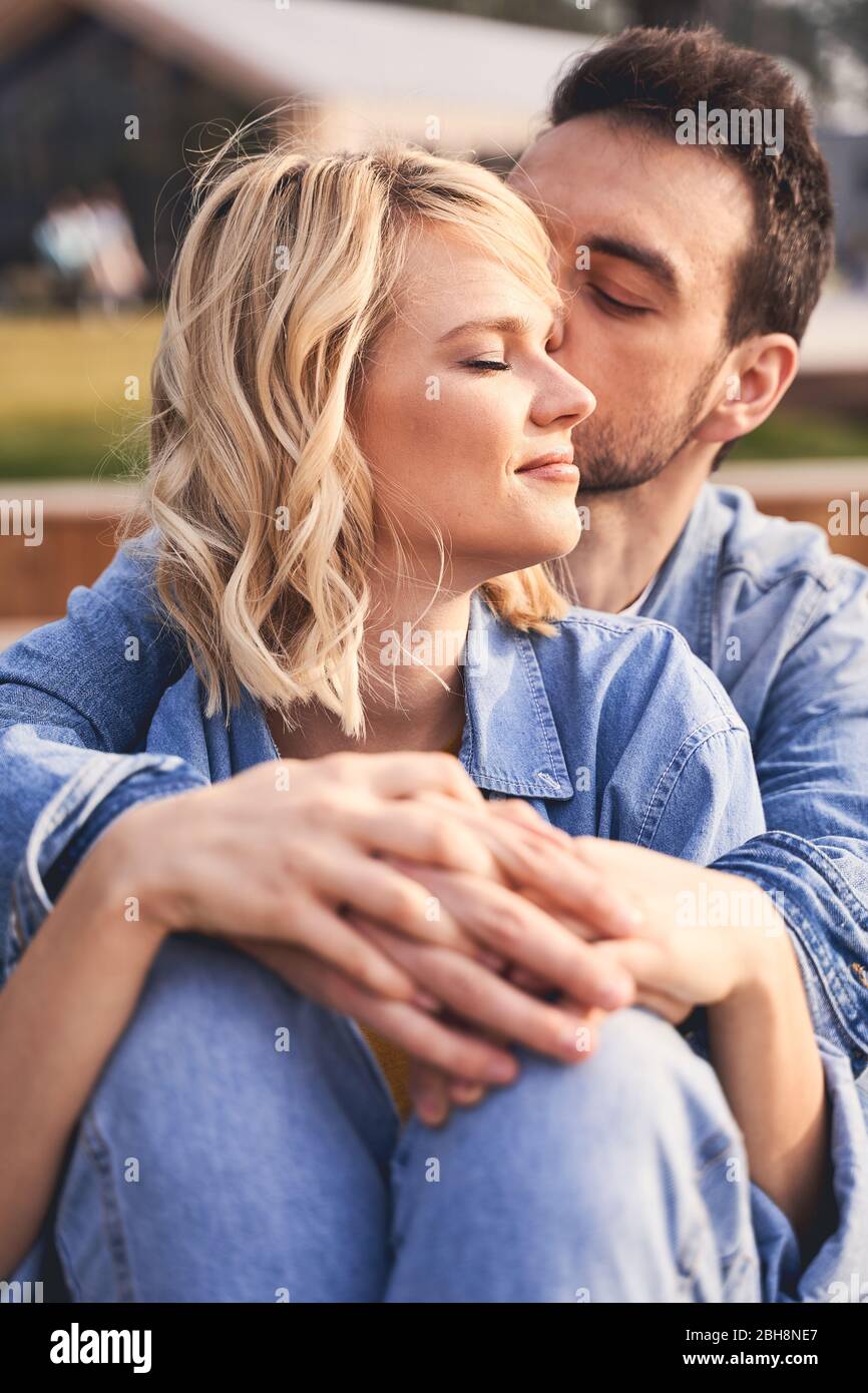 Romantic Caucasian man embracing his smiling girlfriend Stock Photo - Alamy