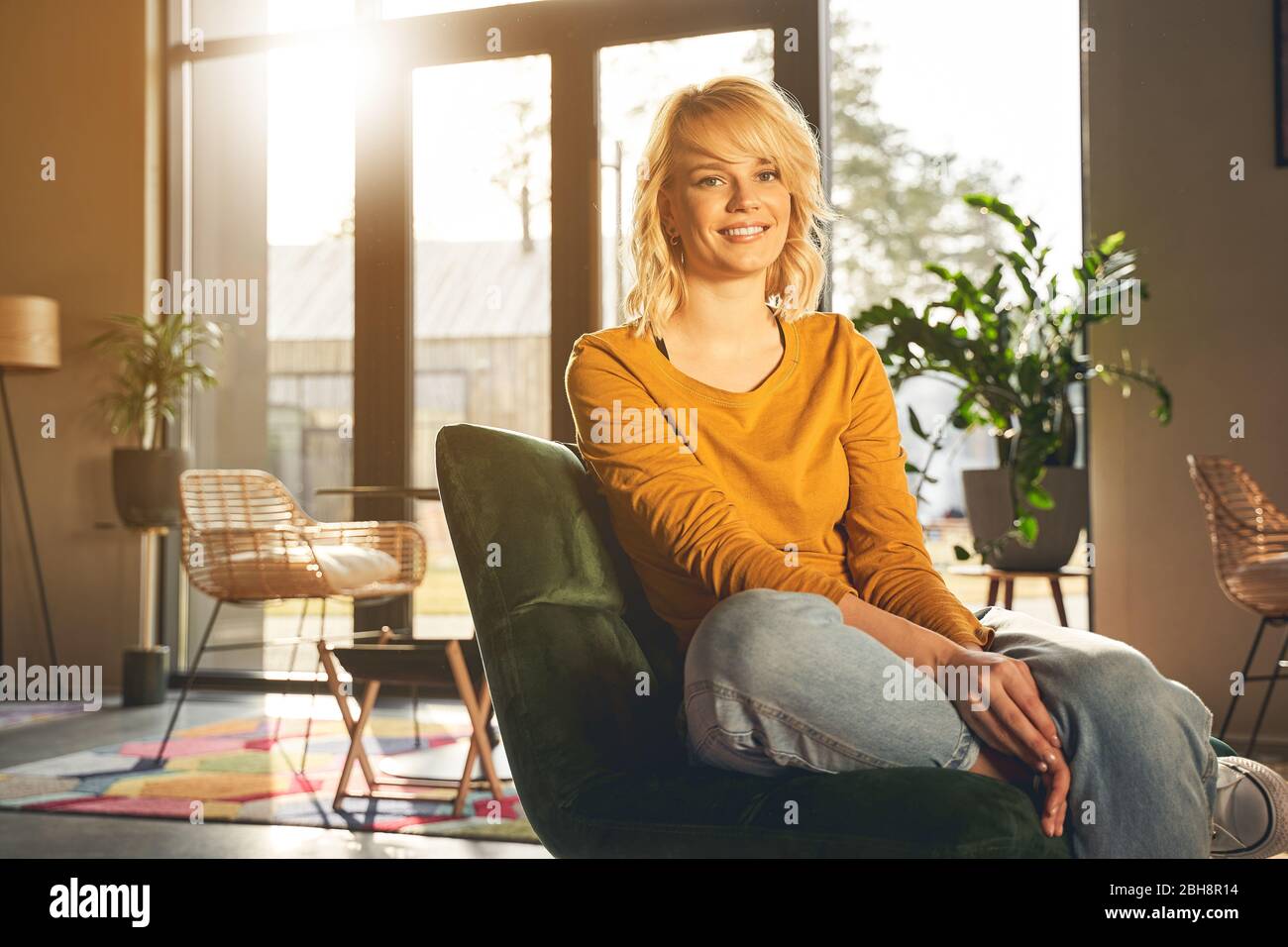 Relaxed pretty female posing for the camera Stock Photo - Alamy