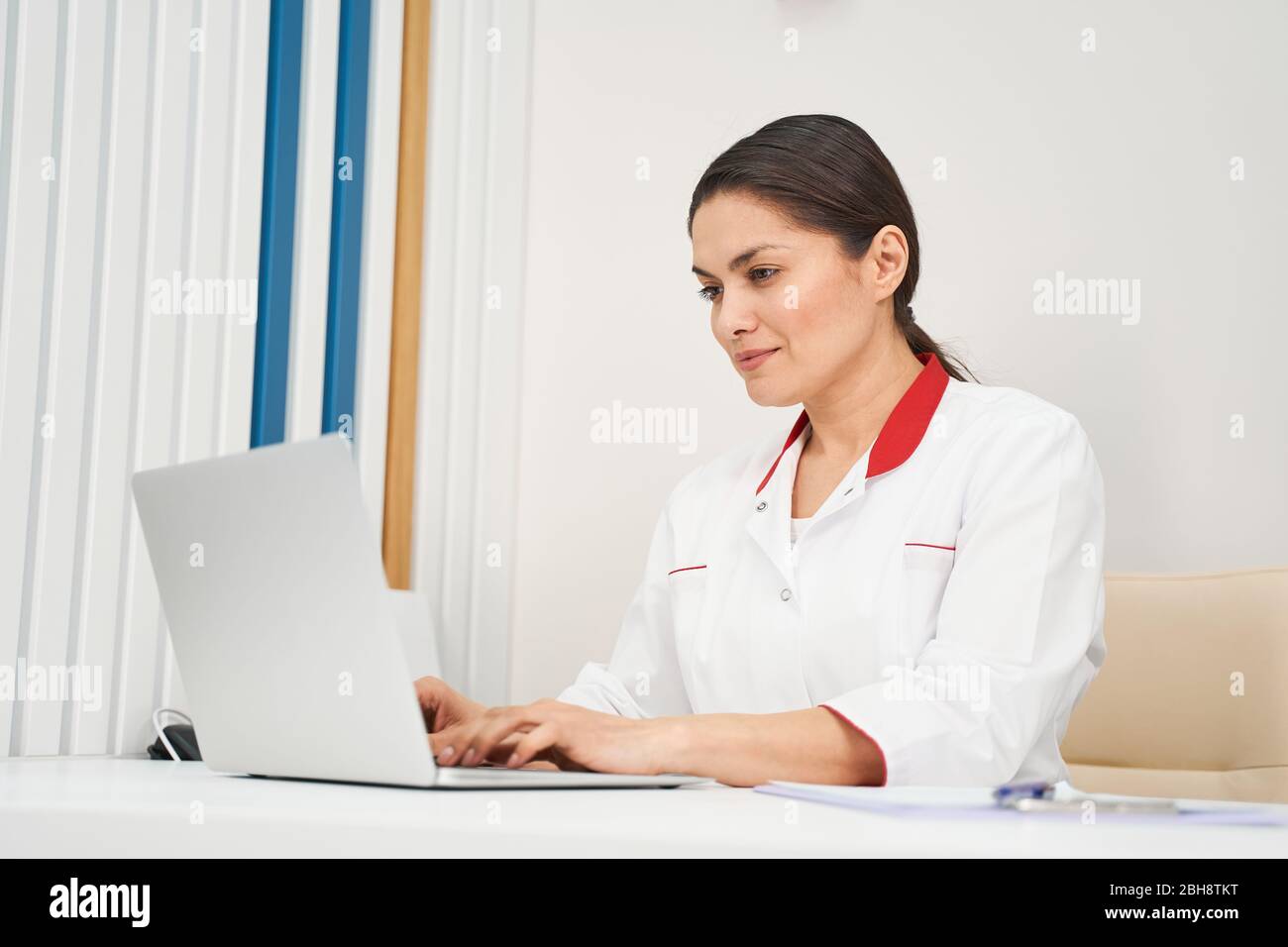 Concentrated brunette female person working at computer Stock Photo - Alamy