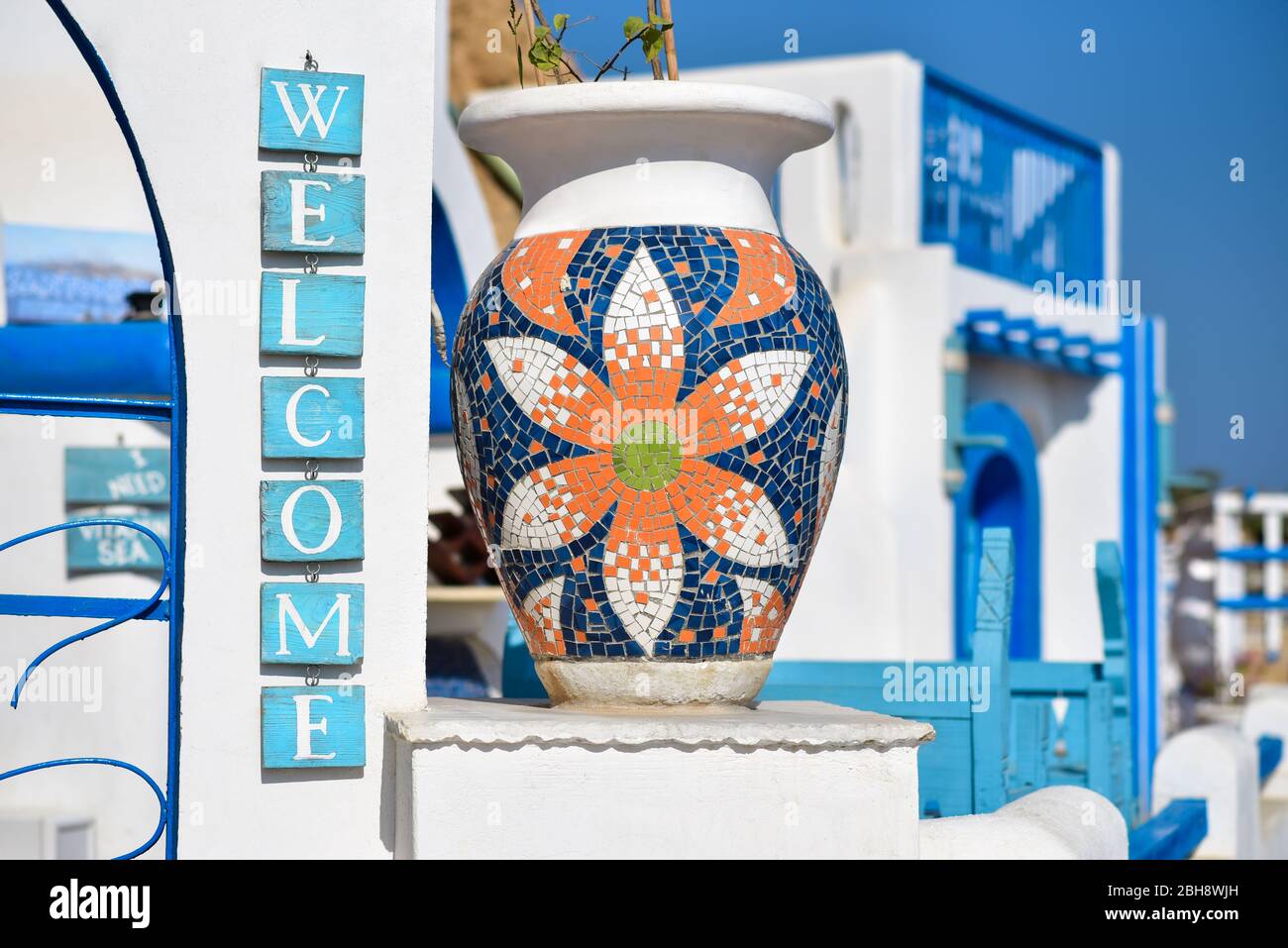 The inscription welcome to the sign of a Greek cafe Stock Photo - Alamy