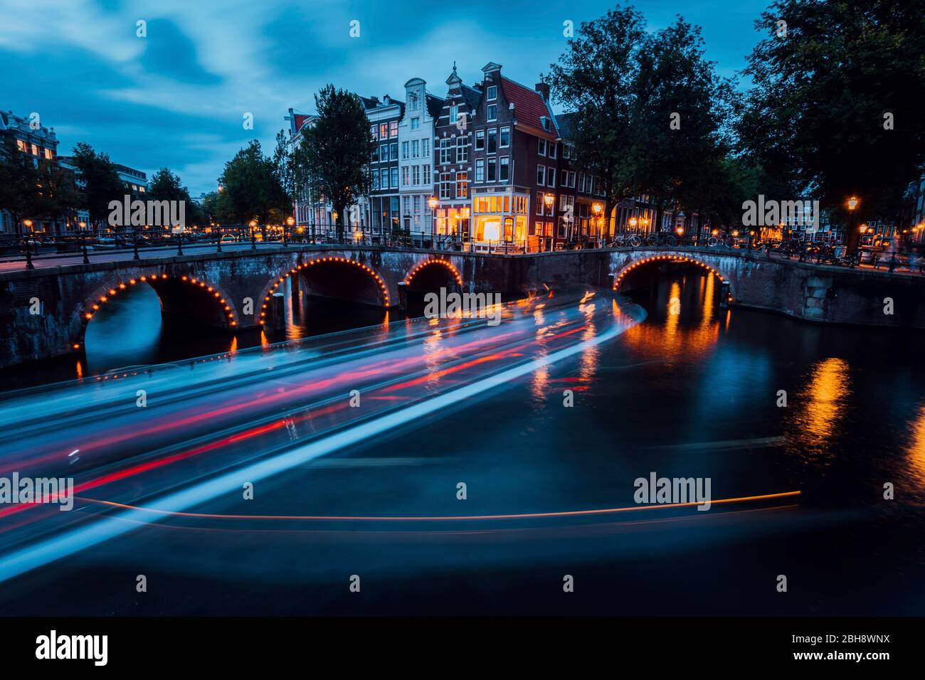 Famous Amsterdam Canal and magic light trails of a Vessel Stock Photo ...