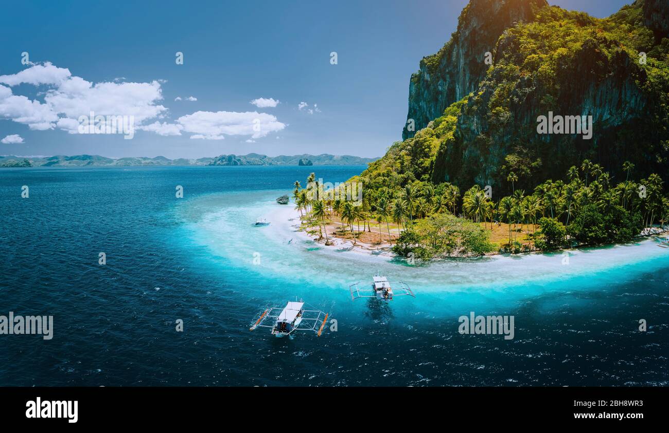 Epic aerial drone panoramic picture of tourist boats arriving tropical ...