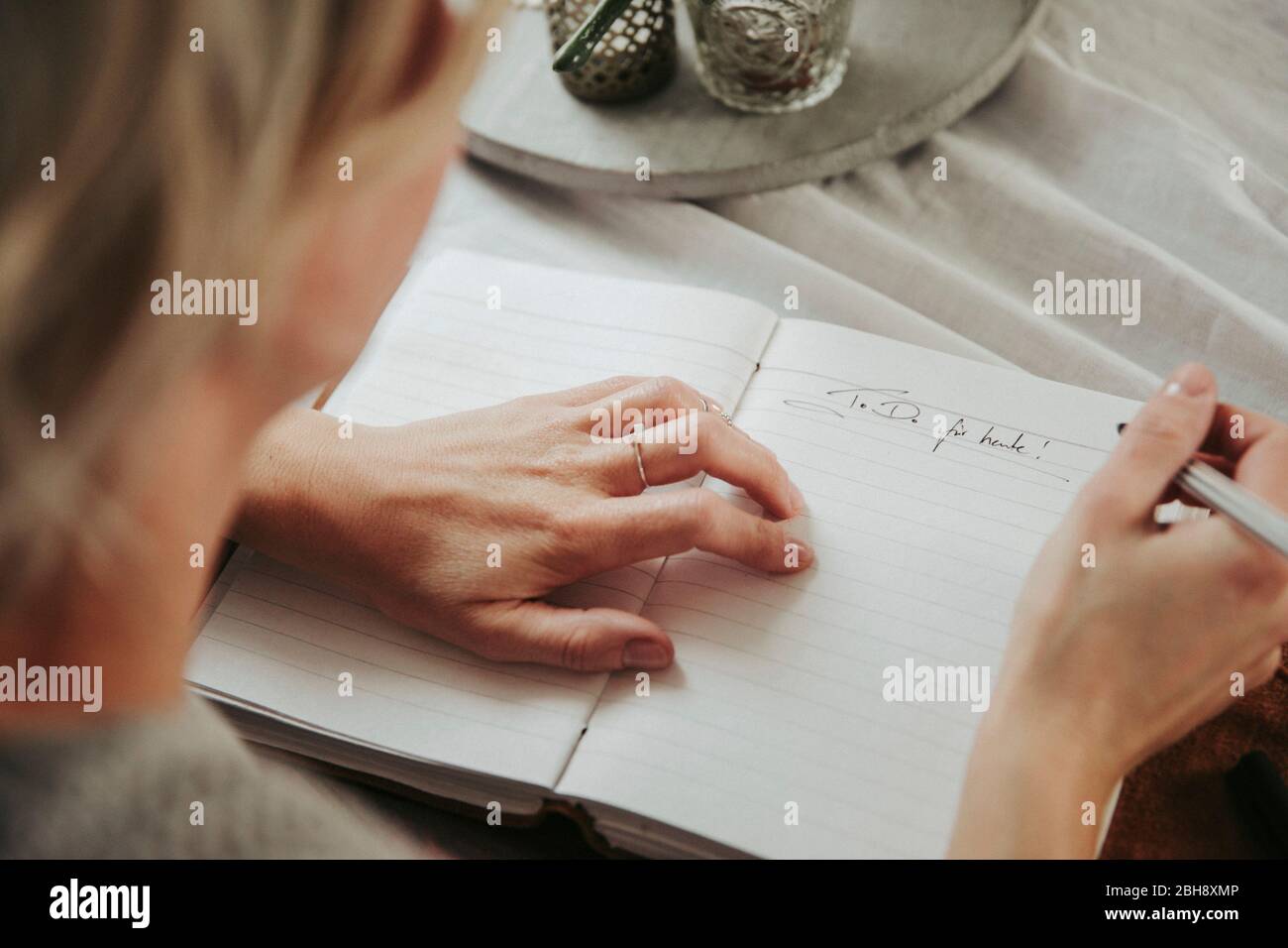 Woman writes on notebook hi-res stock photography and images - Alamy