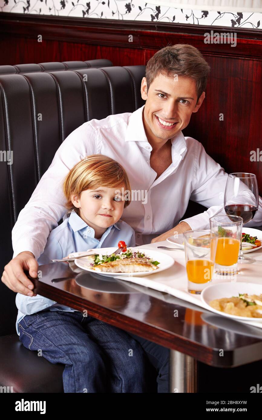 Father and son have lunch together in a restaurant Stock Photo - Alamy