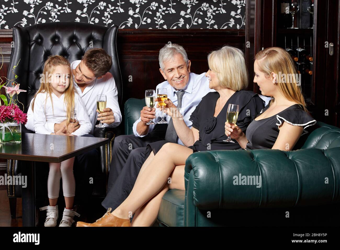 Family with children having a champagne reception in the living room ...