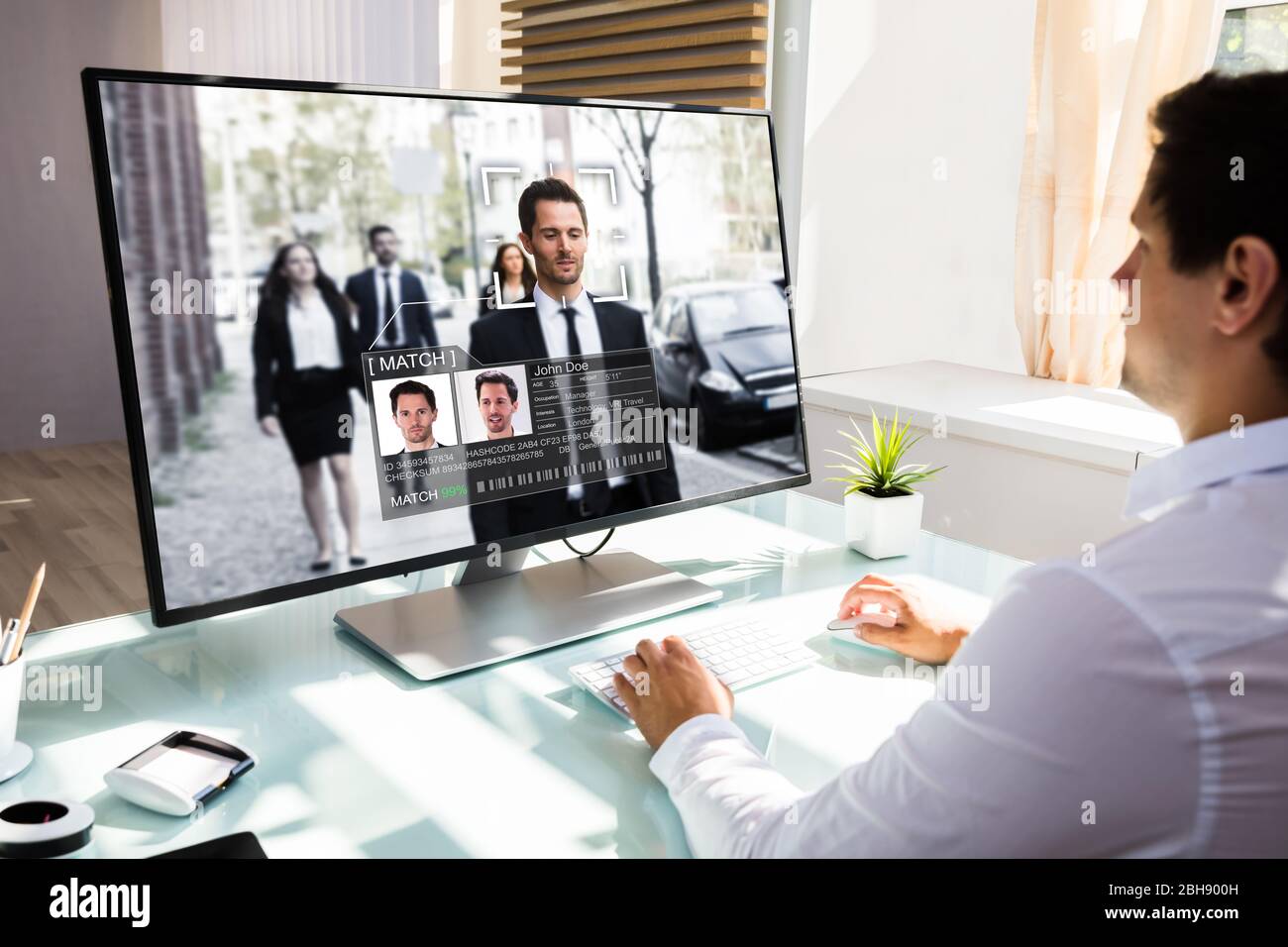 CCTV Operator Looking At Surveillance Footage Using AI Face Recognition ...