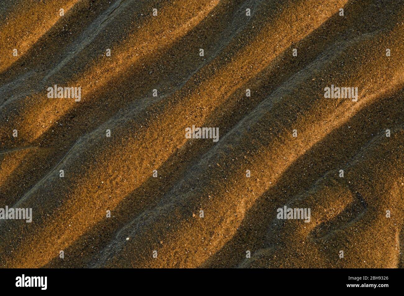 Patterns in the sand on the seashore caused by the waves of tide ...