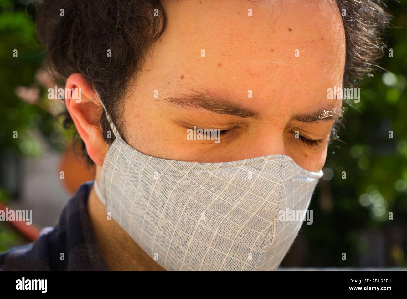 Young man with a mask in pain Stock Photo - Alamy