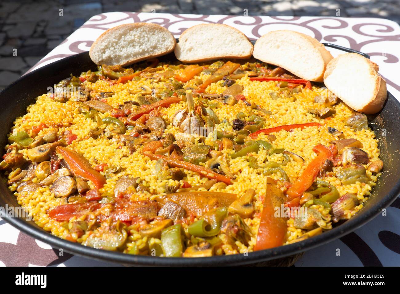 Vegetable paella made on fire with organic ingredients Stock Photo - Alamy