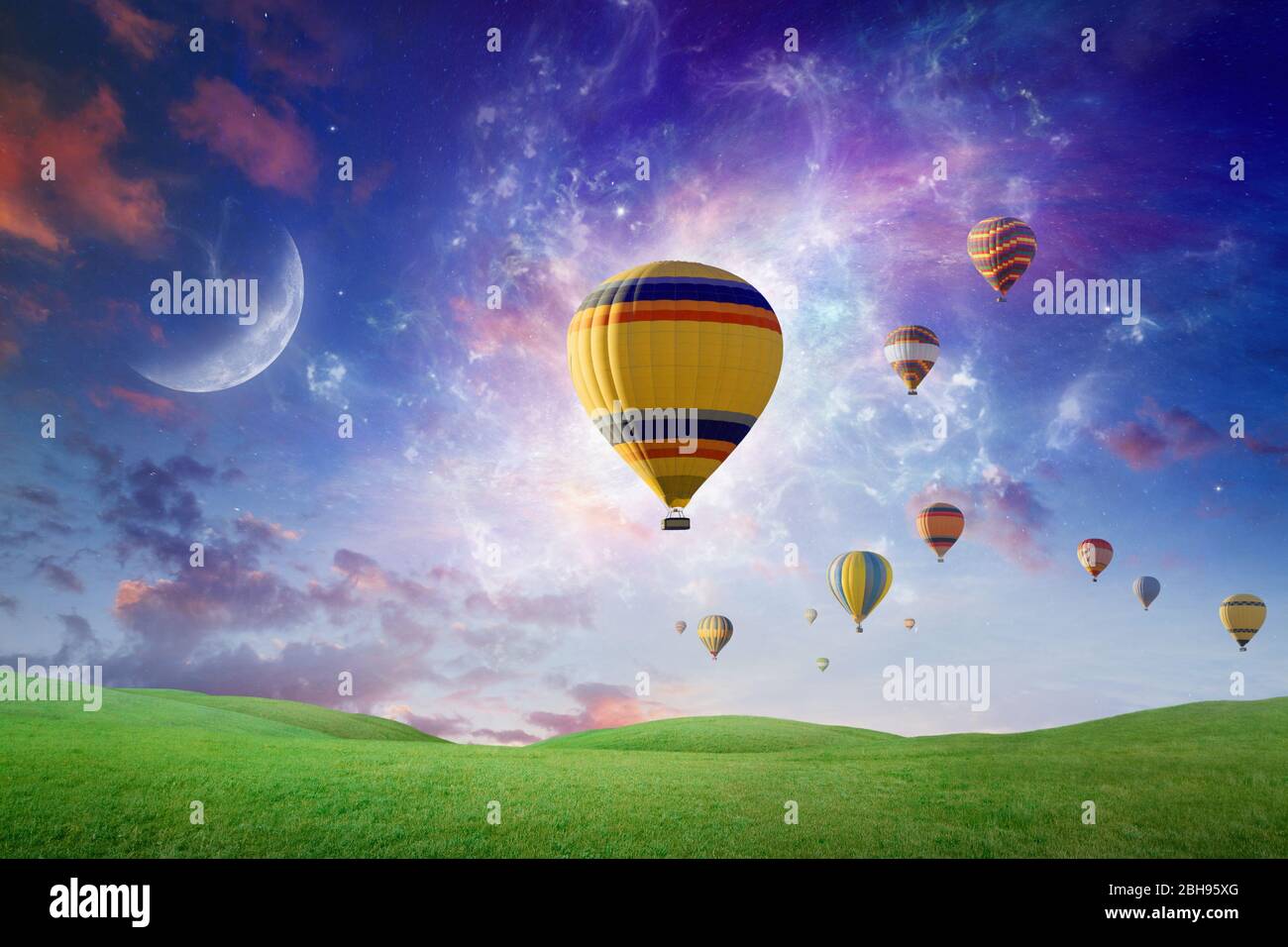 Hot air balloons fly in sunset sky against background of glowing ...