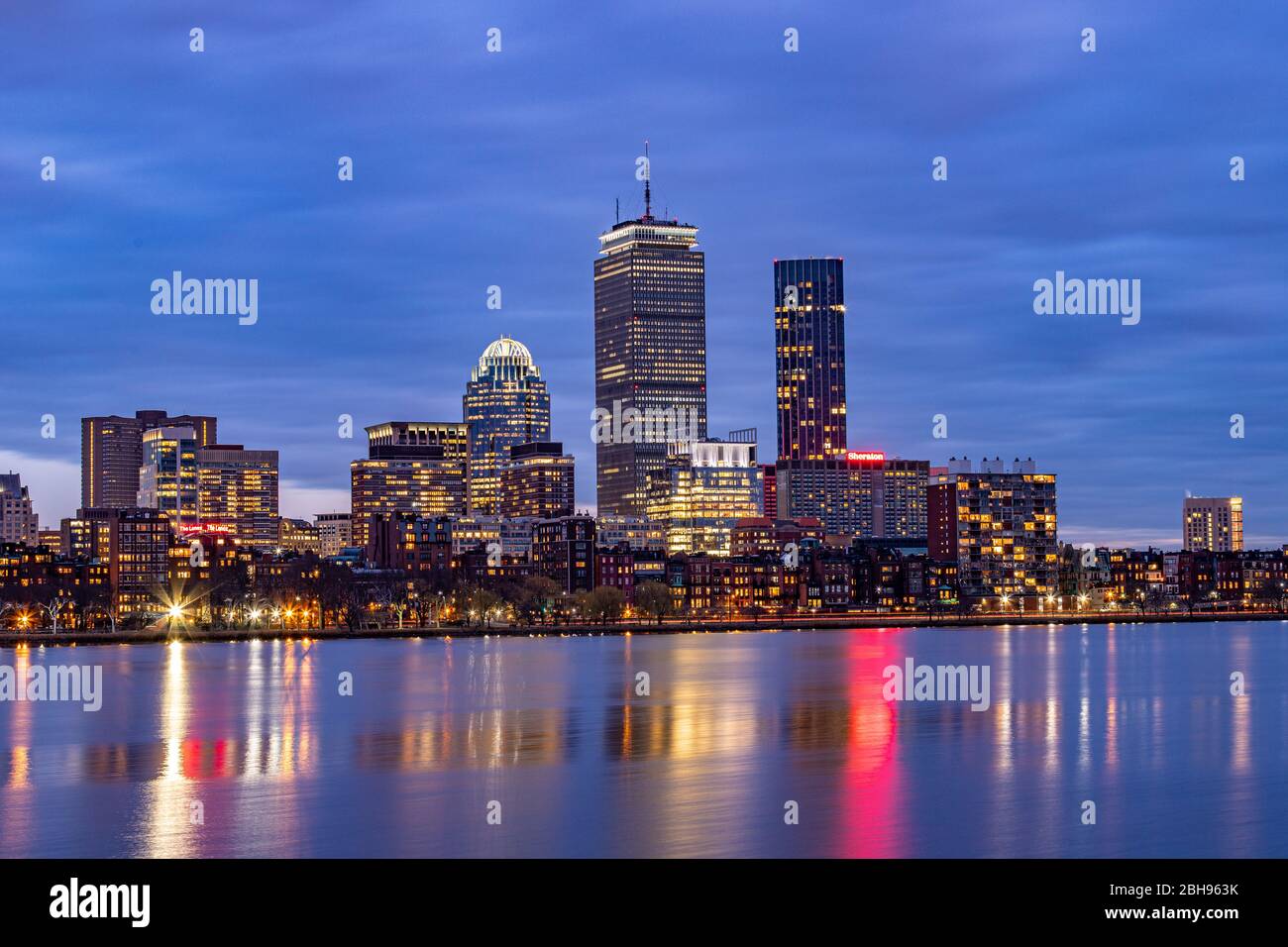 Blue hour cityscape buildings reflecting in water Stock Photo - Alamy