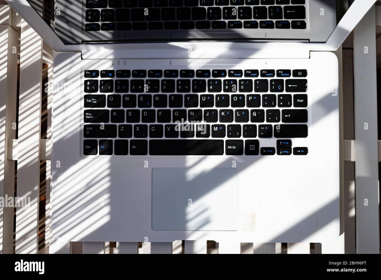 White laptop on a white background Stock Photo - Alamy
