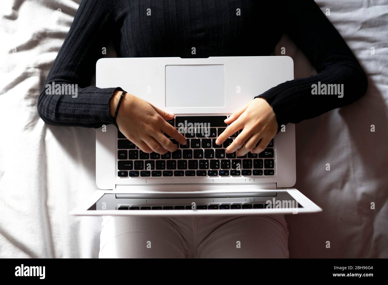 Working in bed laptop on white bed hi-res stock photography and images ...
