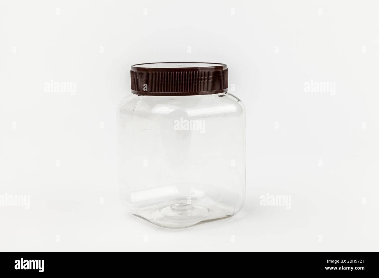 empty transparent plastic jar on white background Stock Photo - Alamy