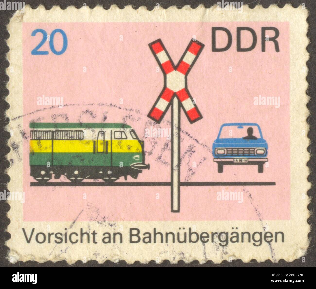 The scanned stamp. German stamp. The car on a railway crossing Stock ...