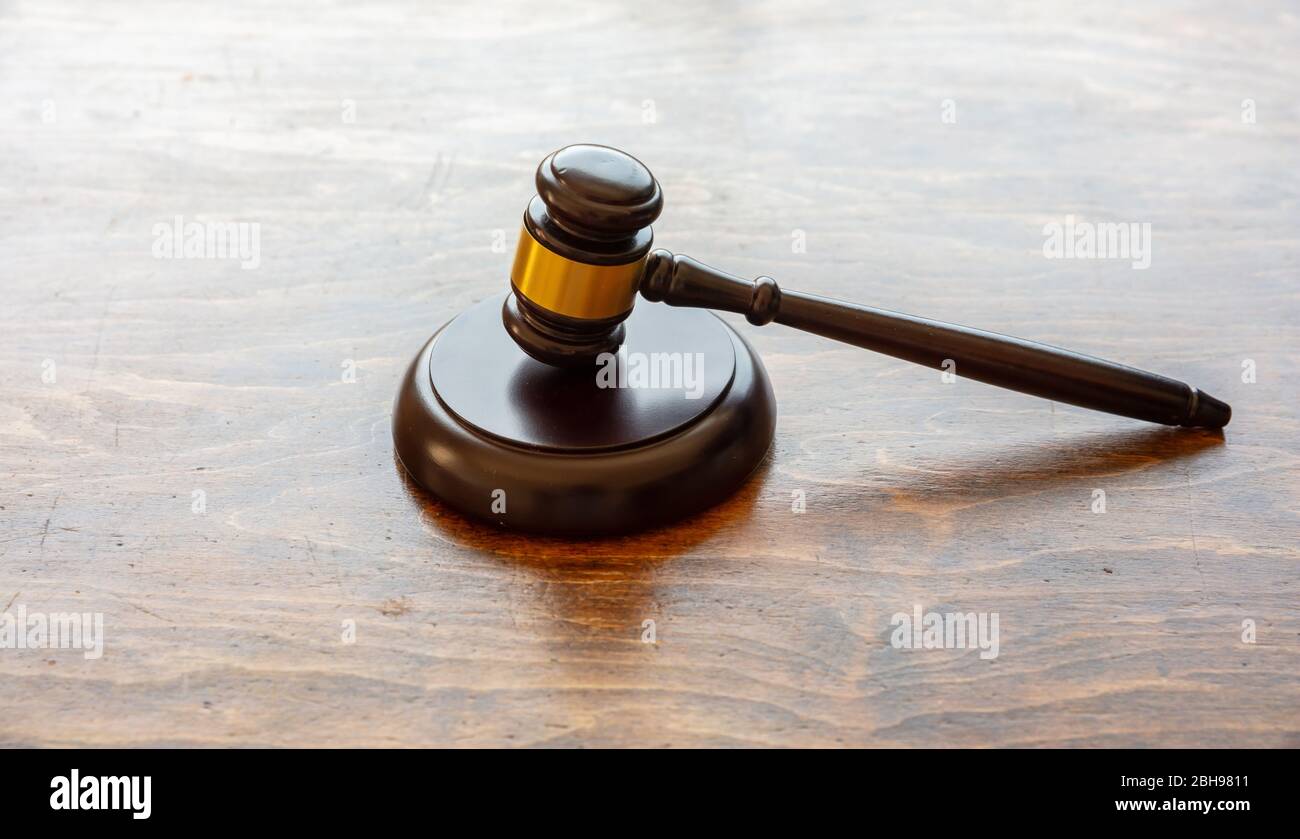 Law theme. Judge gavel on wooden office desk background, close up view ...