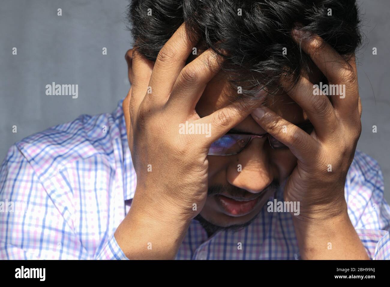 Sad young man hand over mouth, close up Stock Photo - Alamy