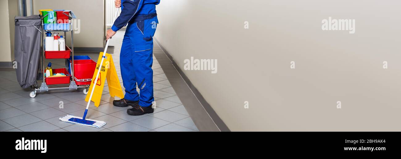Professional Janitor Cleaning Office. Cleaner Using Broom At Workplace ...