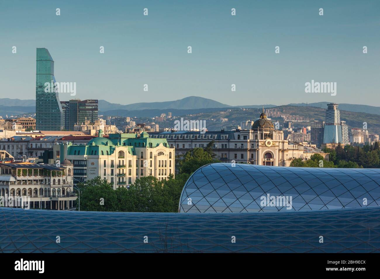 Georgia, Tbilisi, Concert Hall and Biltmore Hotel Tower, dawn Stock ...