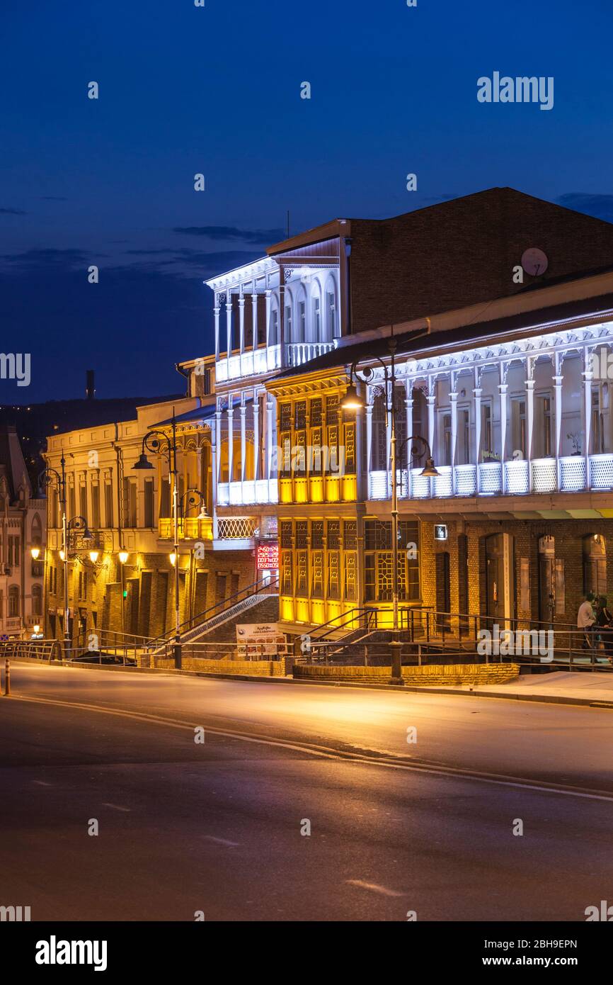 Georgia, Tbilisi, lit buildings along Pushkin Street, dawn Stock Photo ...
