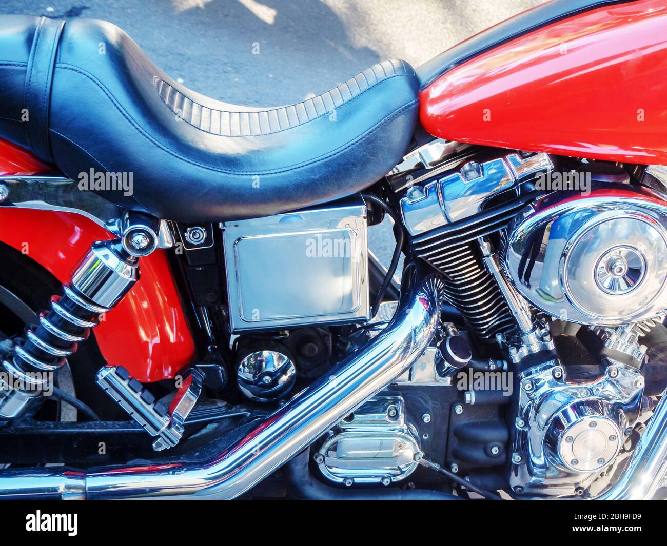 Closeup motorcycle engine side view reflective metal and black leather ...