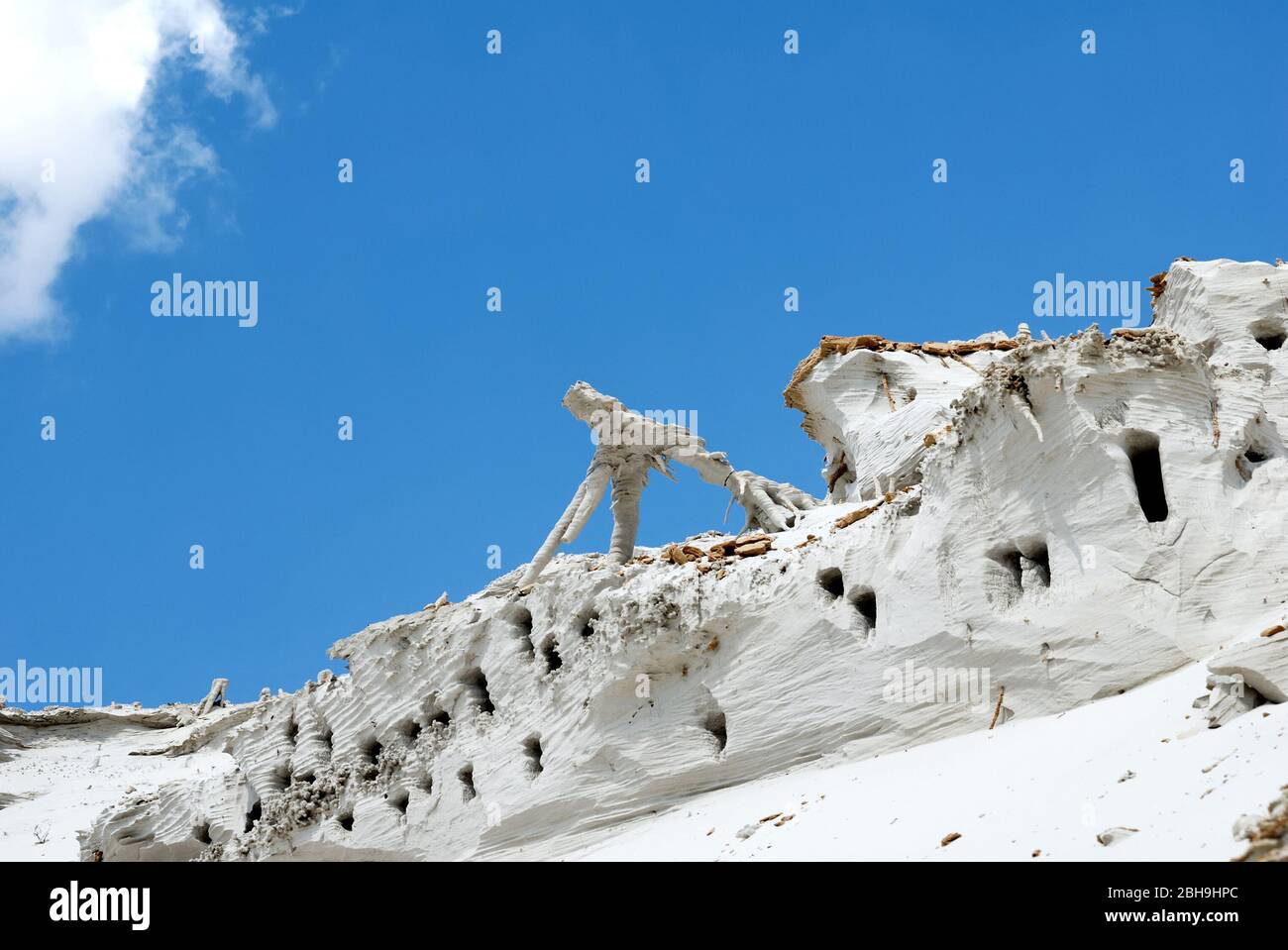 Sculptures from sand against a slope of sandy mountain Stock Photo - Alamy