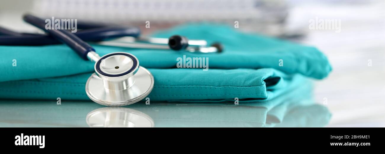 Medical stethoscope head lying on green doctor uniform Stock Photo - Alamy