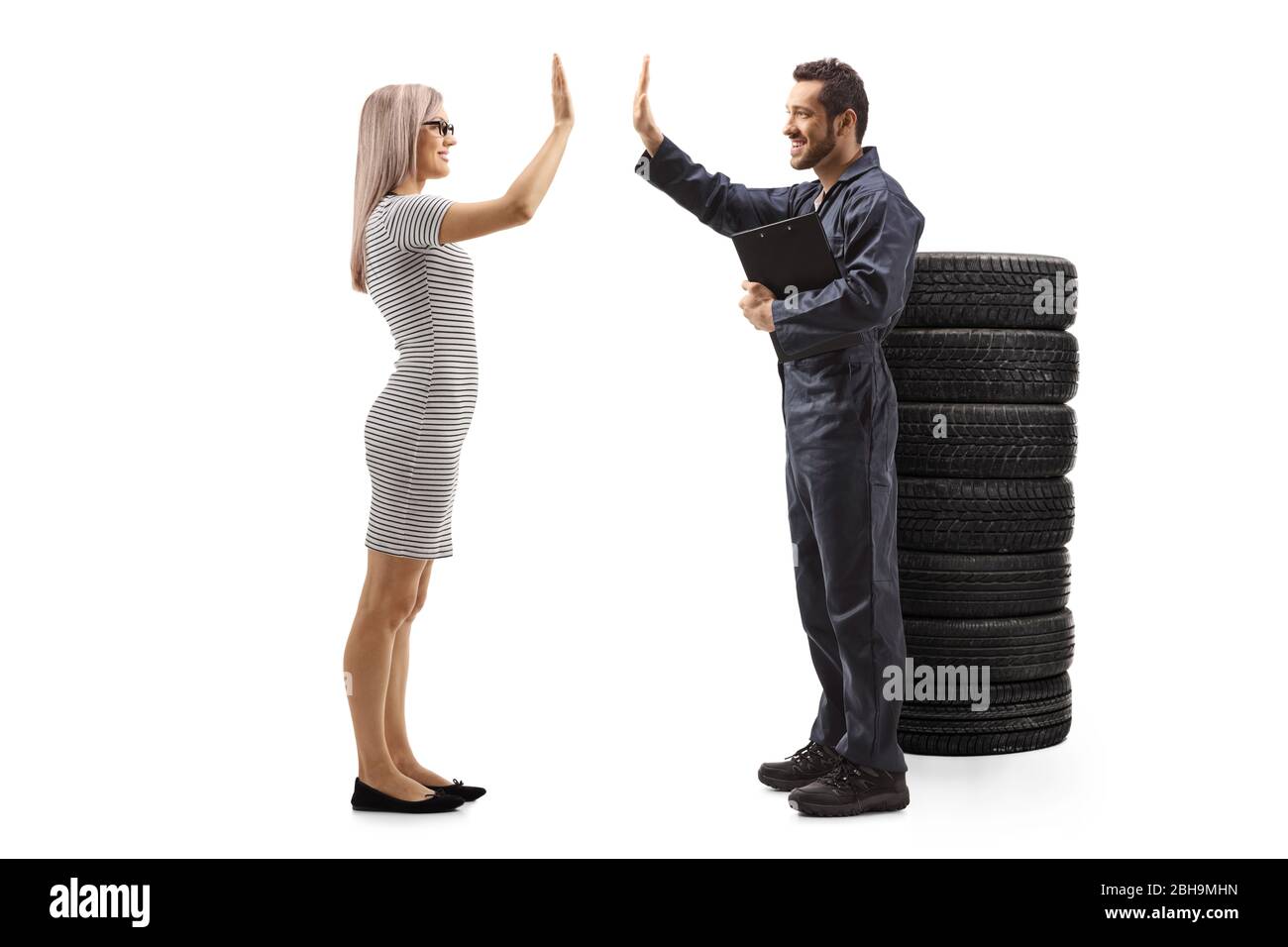 Full length shot of an auto mechanic and a woman gesturing high-five ...