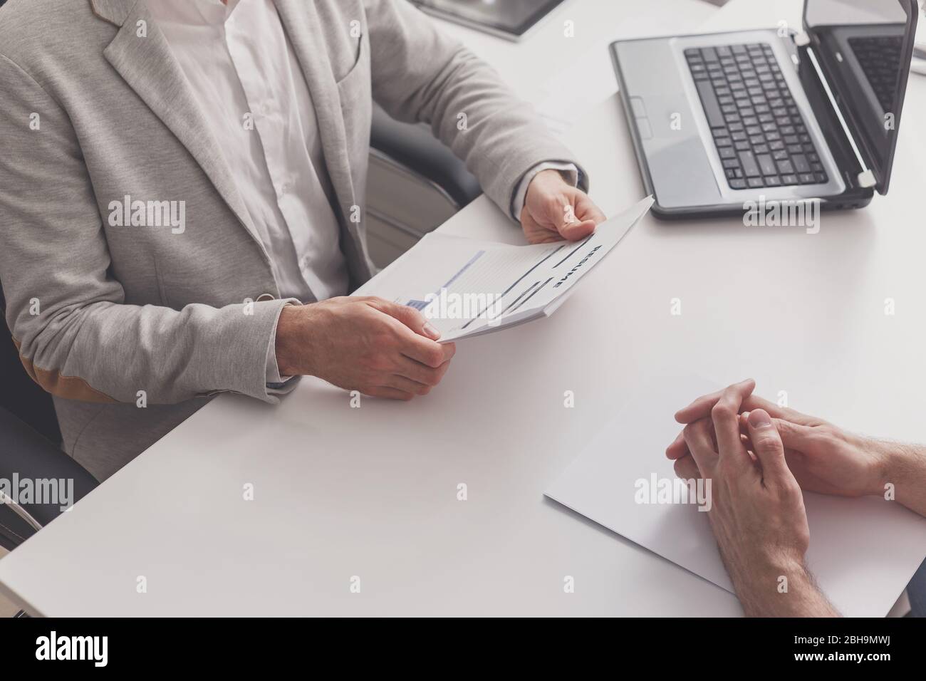 Job interview in the office. hr manager reading resume of job seeker ...