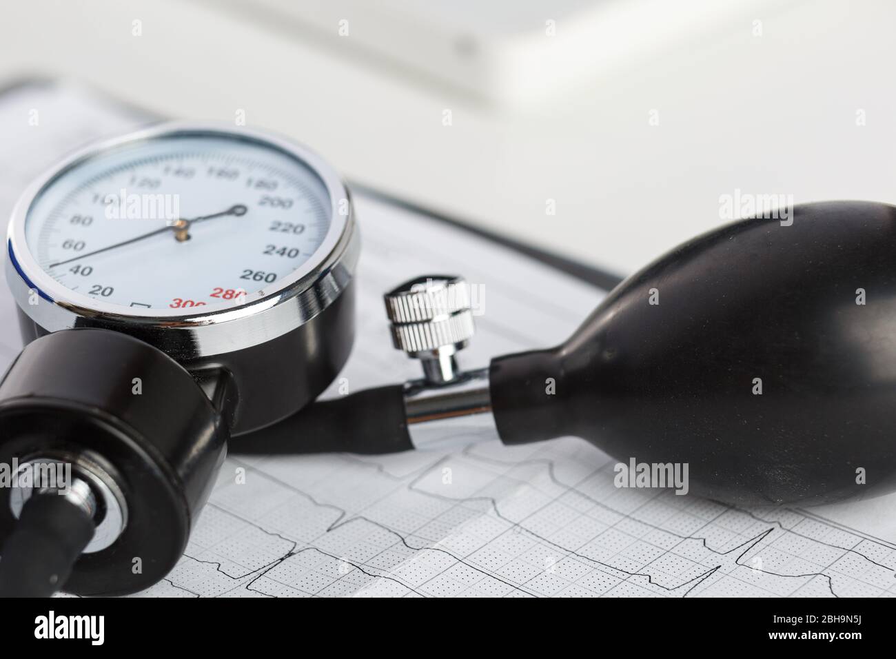 Medical manometer lying on cardiogram chart closeup Stock Photo - Alamy
