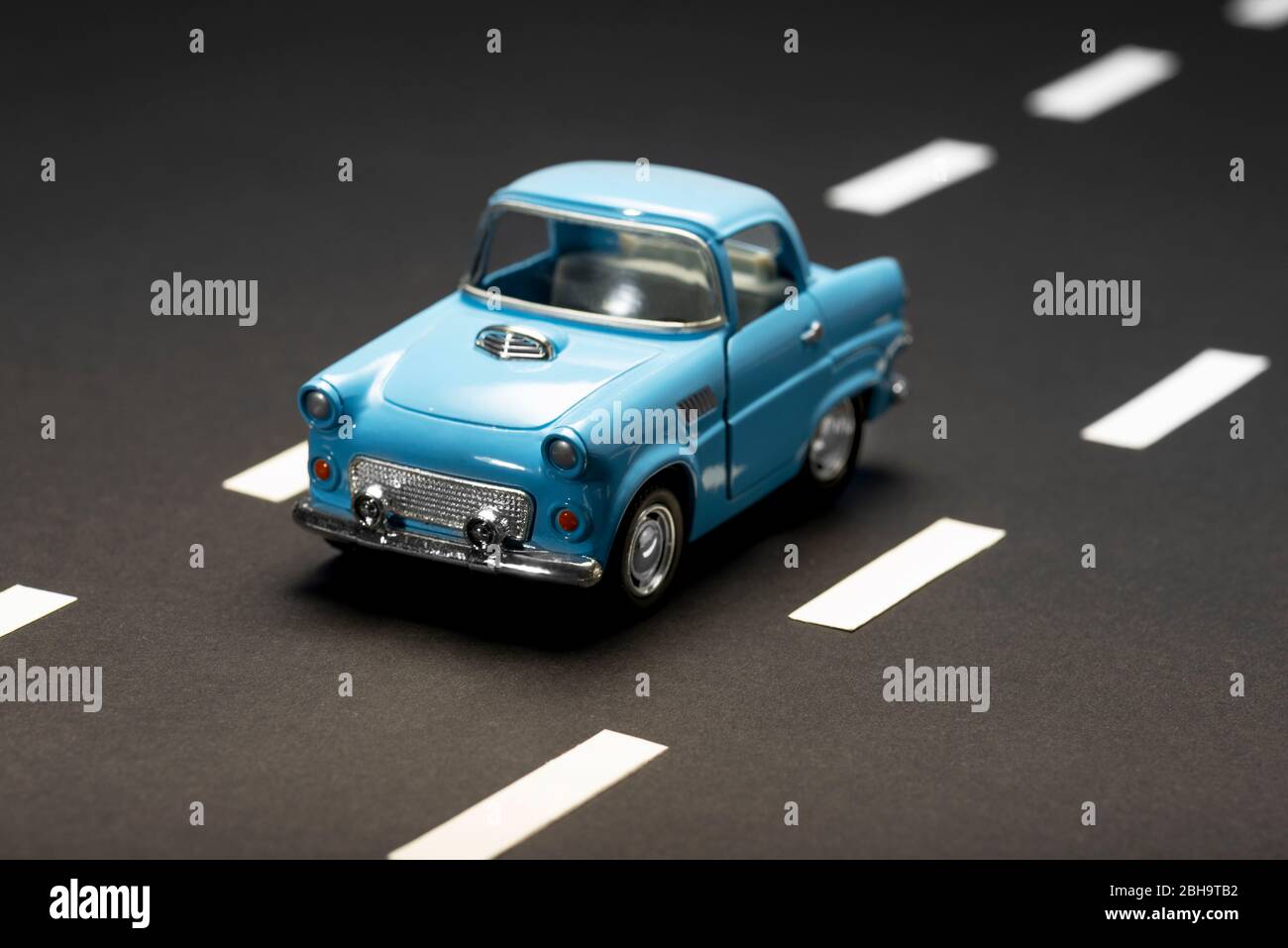 Front view of a blue toy car on on an asphalt road Stock Photo - Alamy