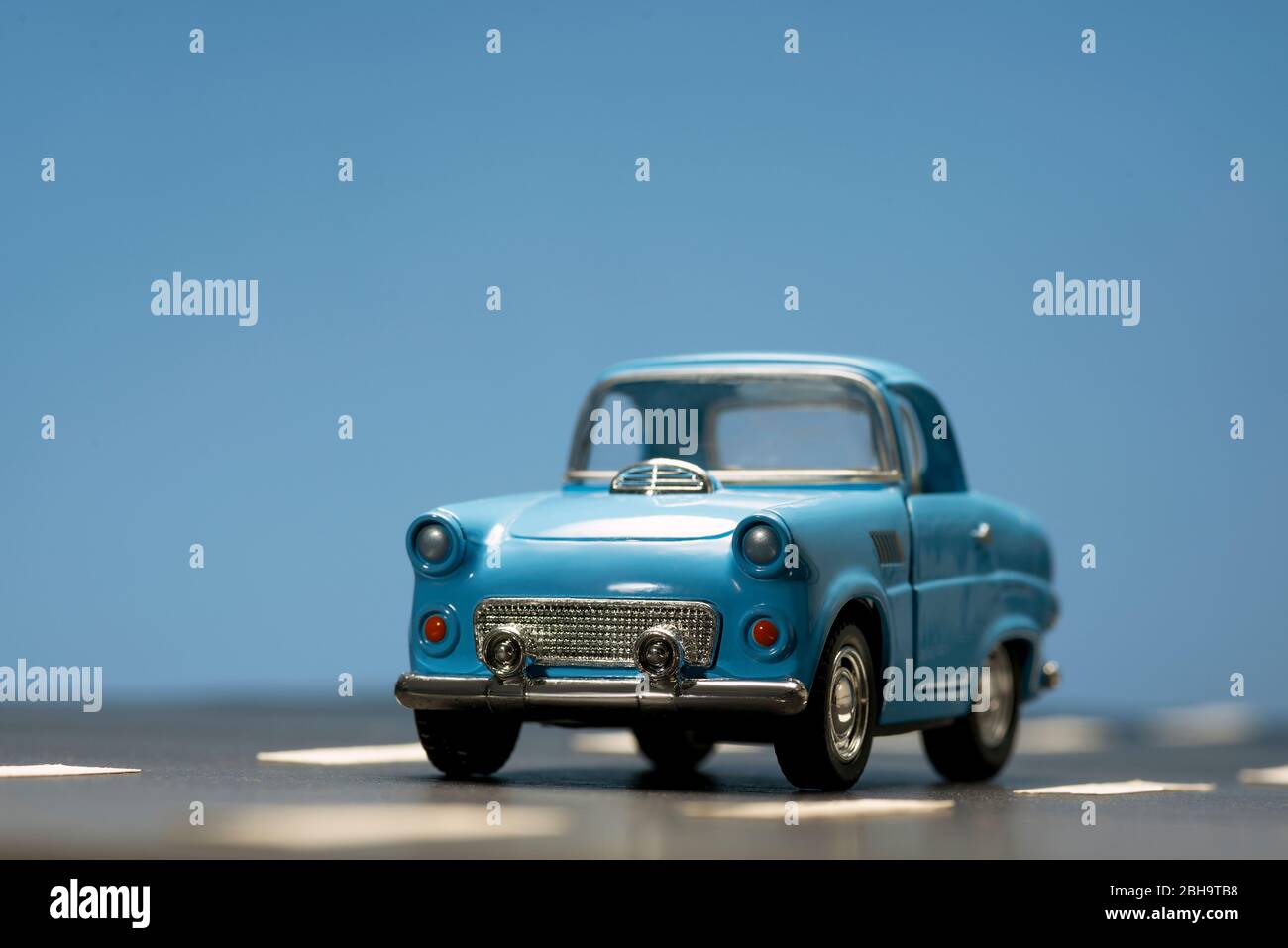 Front view of a blue toy car on on an asphalt road Stock Photo - Alamy