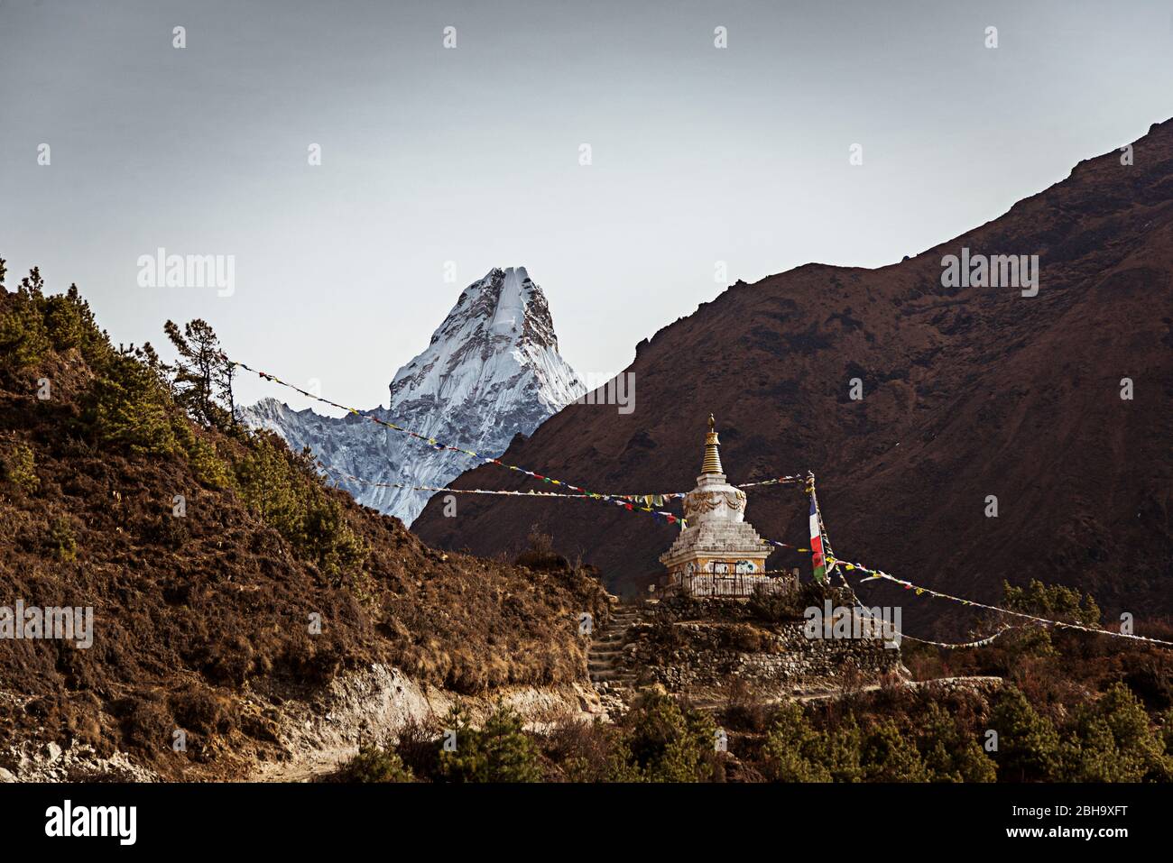 Temple with prayer flags, walk, Ama Dablam in the background, landscape ...