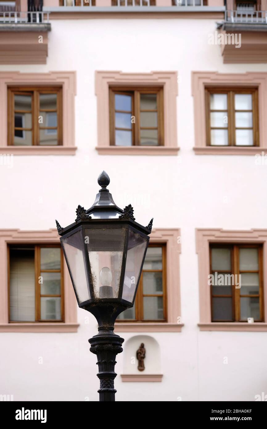 A nostalgic street lamp faces an old newly renovated residential and ...