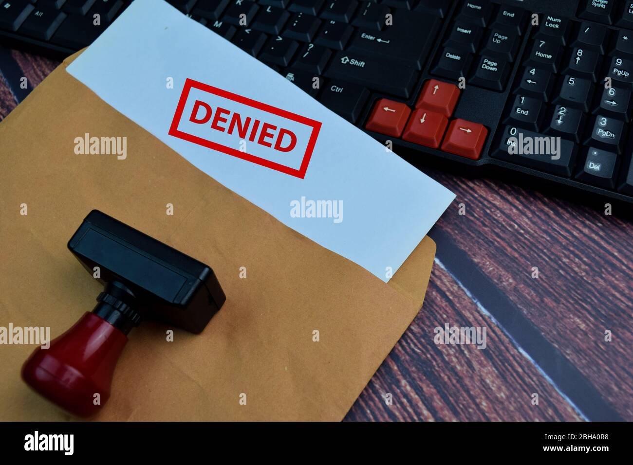 Red Handle Rubber Stamper and Denied text Isolated on wooden table ...