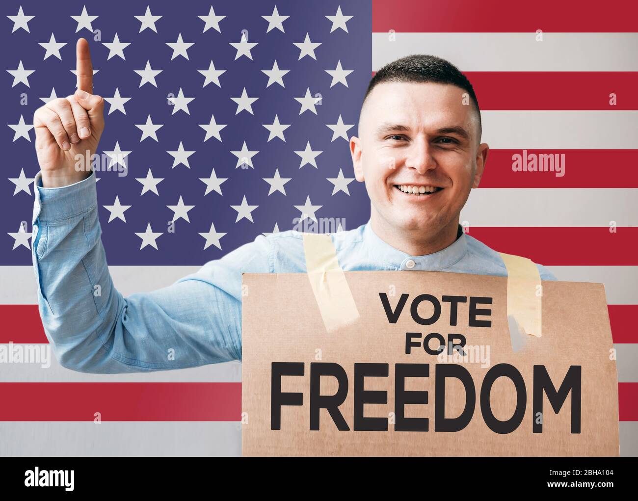 Man with arm raised holding sign with text vote for freedom with ...