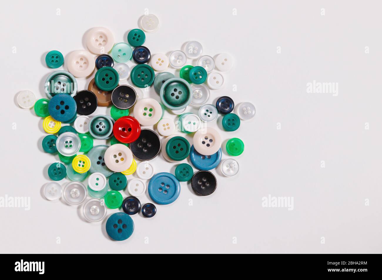 Colorful mixed sewing buttons on white background, flat lay. Top view ...